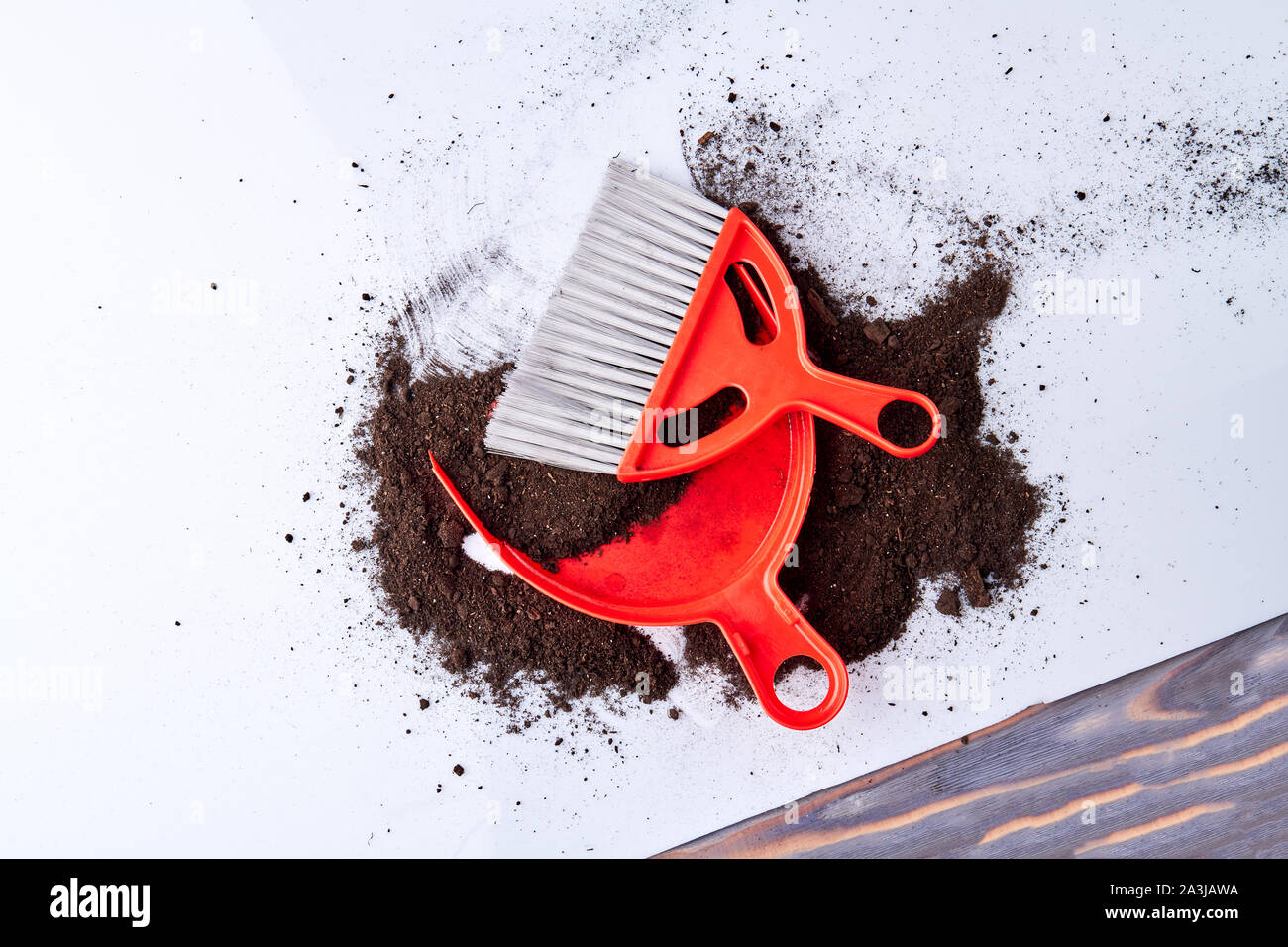 Dustpan, dust brush and heap of soil on the floor Stock Photo - Alamy