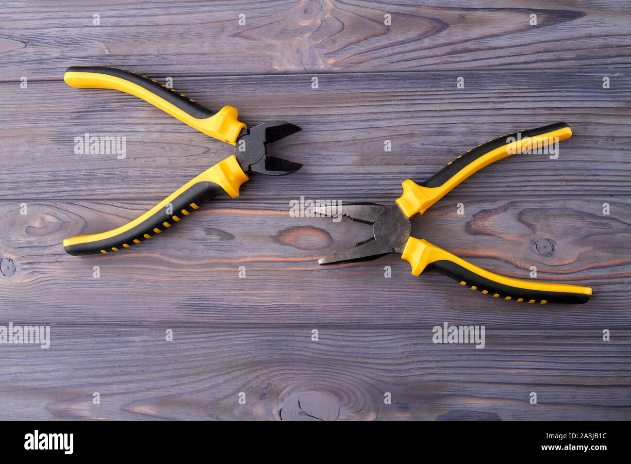Two hand tools pliers with rubber handles Stock Photo - Alamy