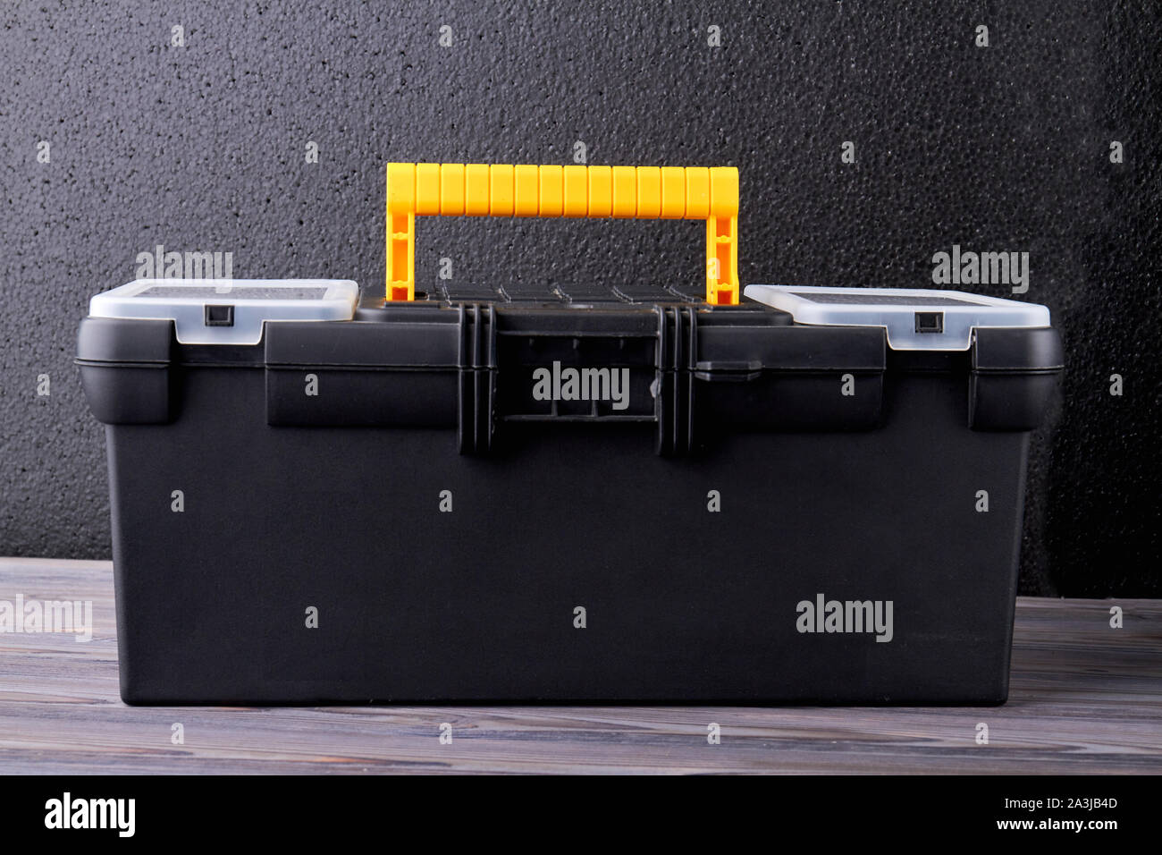 Black tool box with yellow handle Stock Photo - Alamy