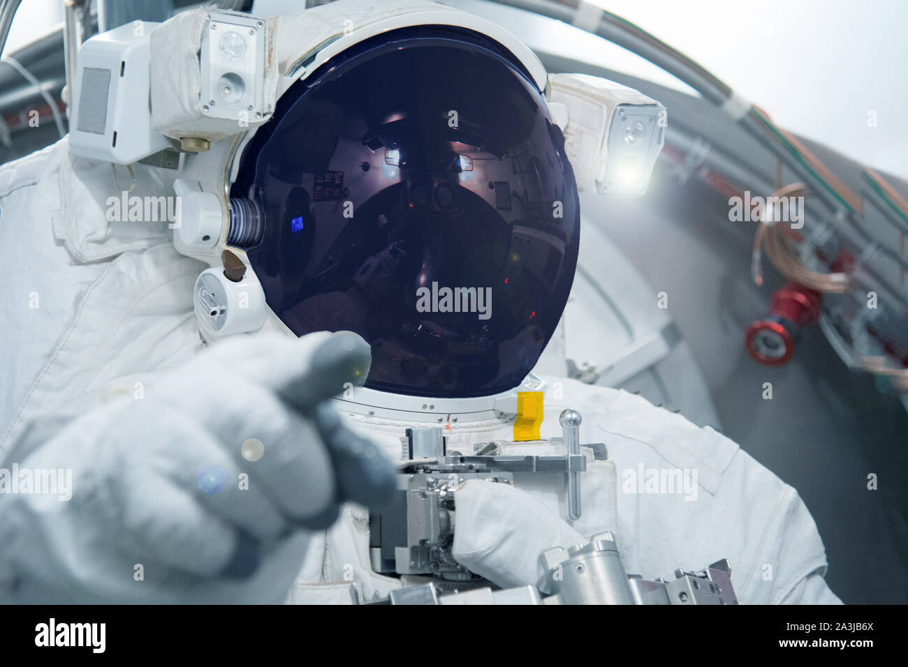 Astronaut in a spacesuit. Point finger forward. Elements of this image ...