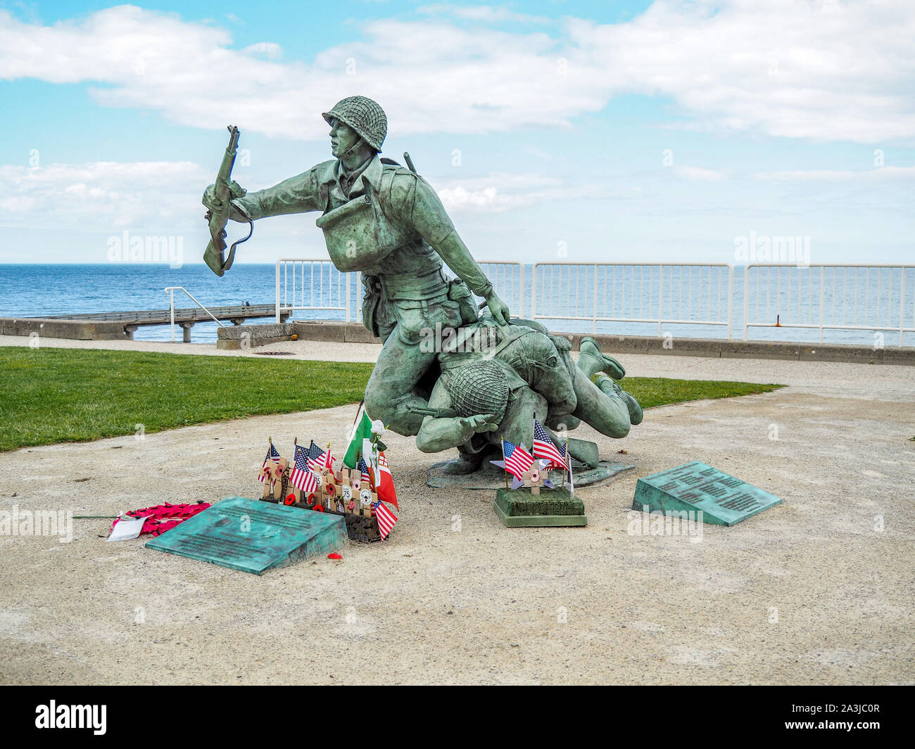 Memorial depicting soldier carrying wounded comrade at Omaha Beach ...