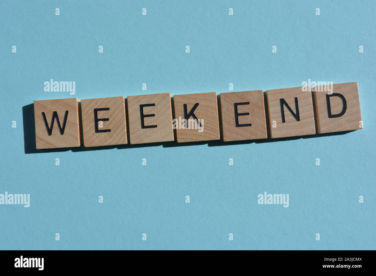 Weekend in 3d wooden alphabet letters on a light blue background with ...