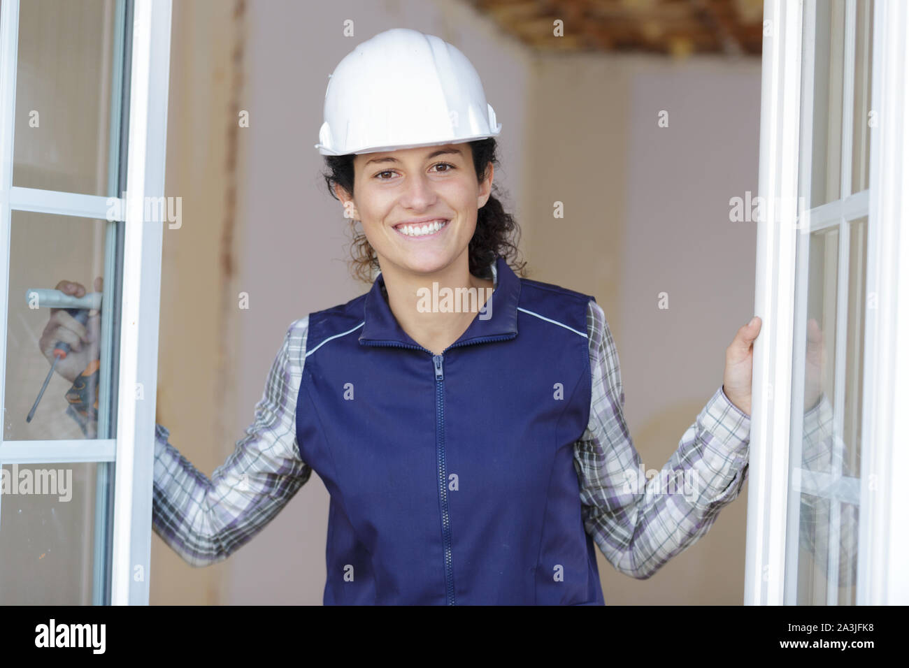 happy female installing a window Stock Photo - Alamy
