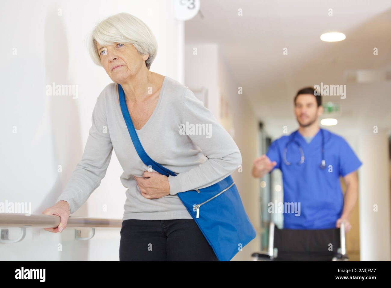 man trying to help female senior Stock Photo - Alamy