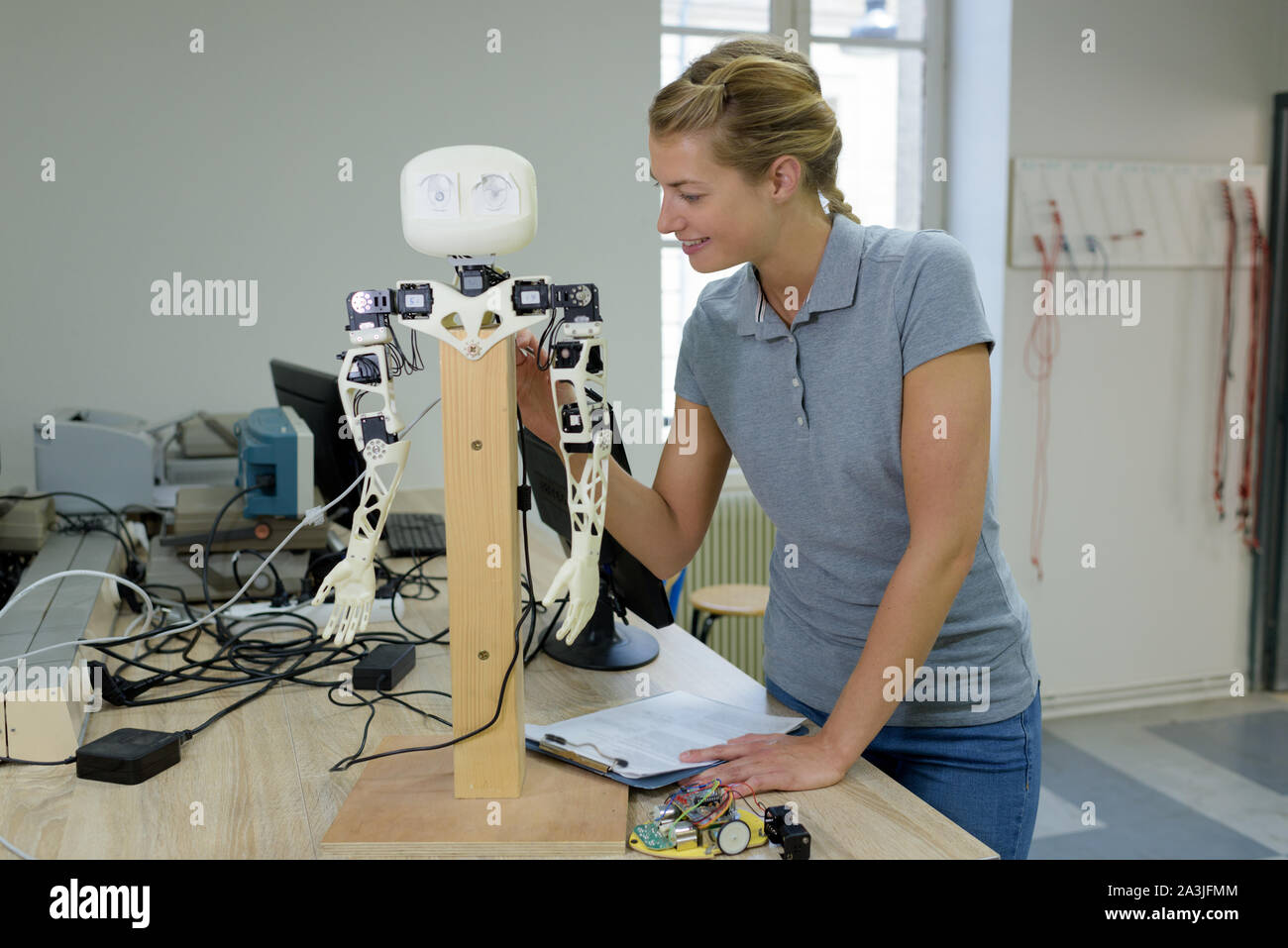a woman fixing robotic arm Stock Photo - Alamy
