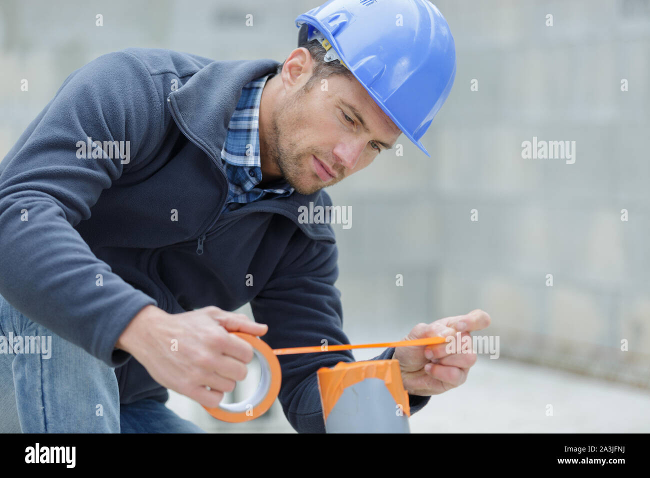 worker man suit construction worker in safety orange tape Stock Photo ...