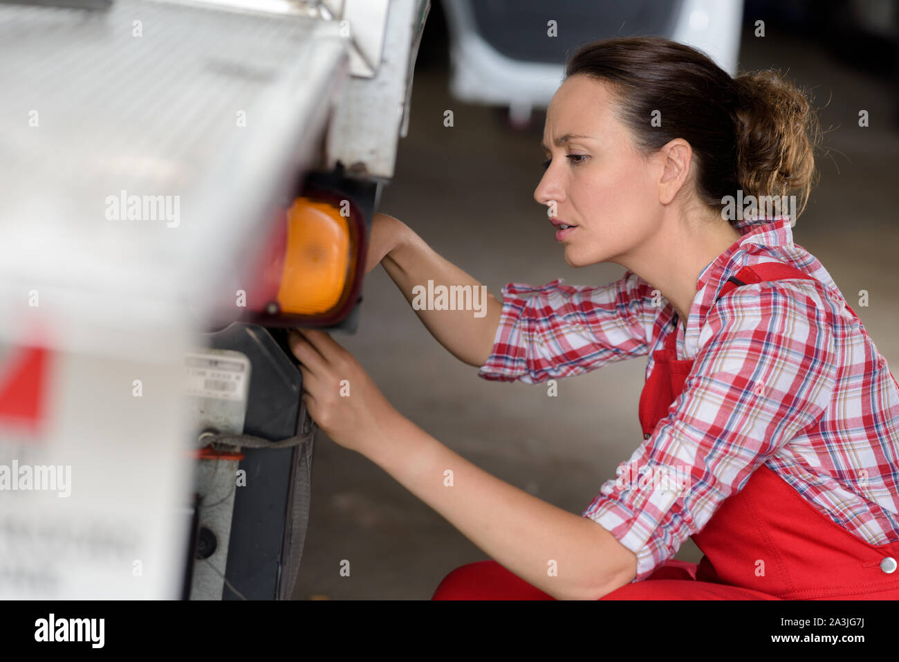 Woman changing tyre in hi-res stock photography and images - Alamy