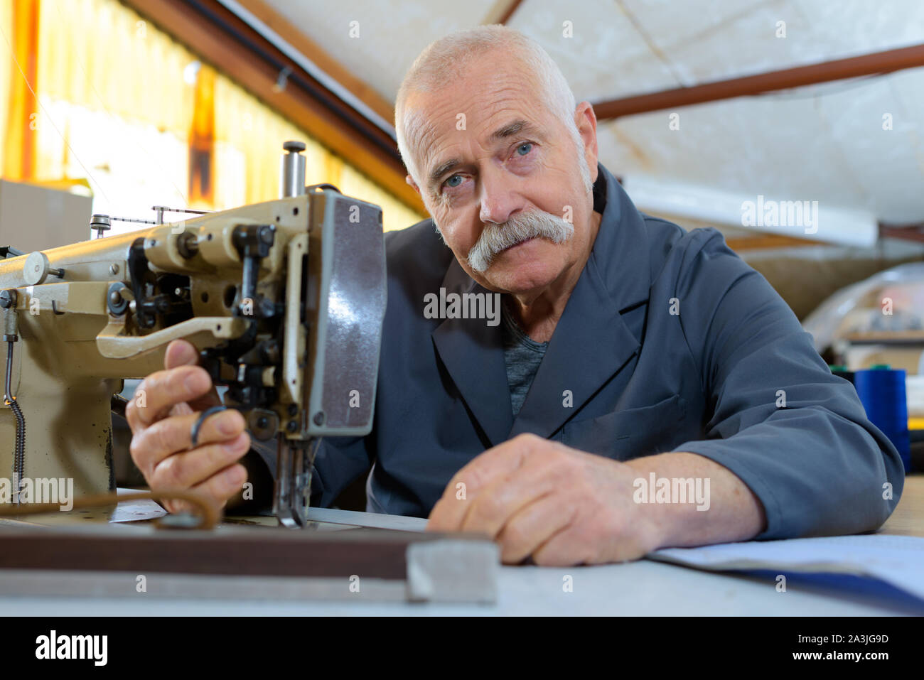a worker using sawing machine Stock Photo - Alamy