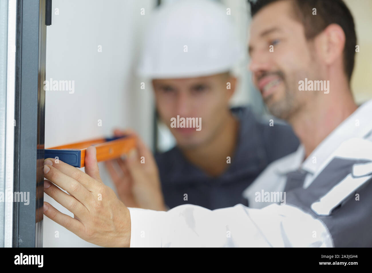 Happy young builder measuring hi-res stock photography and images - Alamy