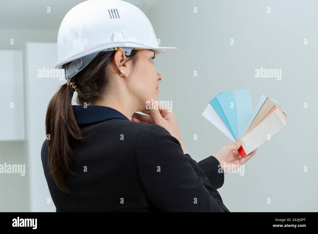 female interior designer picking the right color for the wall Stock ...