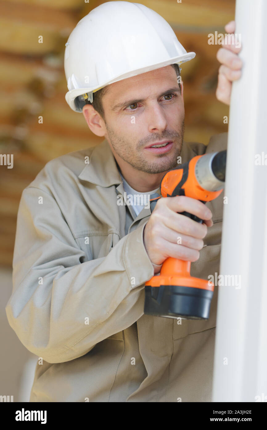 male construction worker using cordless drill Stock Photo - Alamy