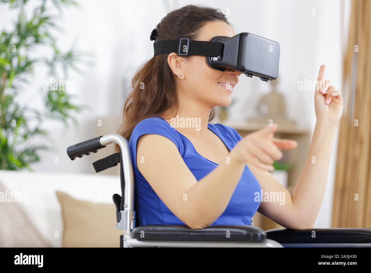 disable woman using a virtual reality mask Stock Photo - Alamy