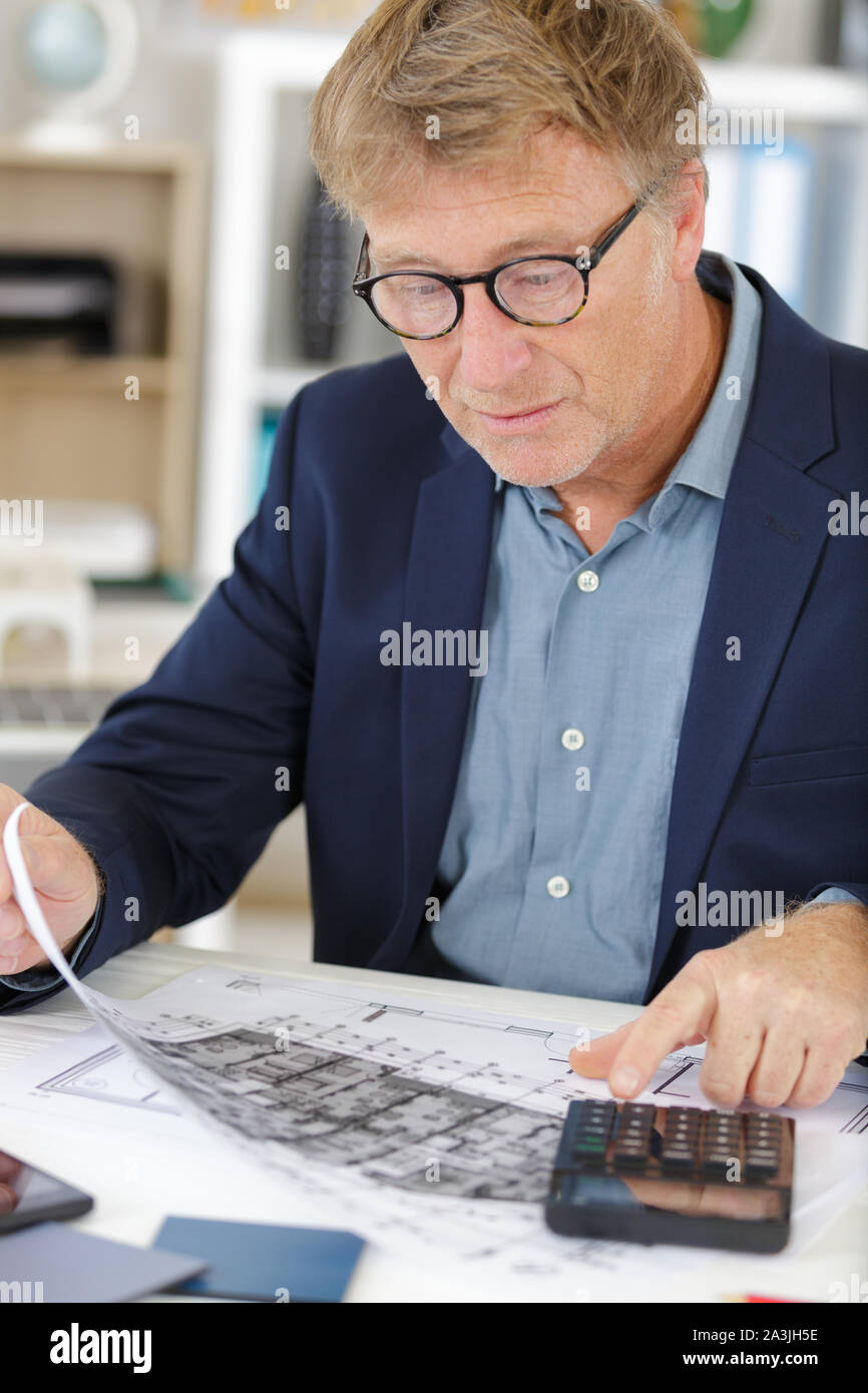 architect man working with calculator and blueprints Stock Photo - Alamy