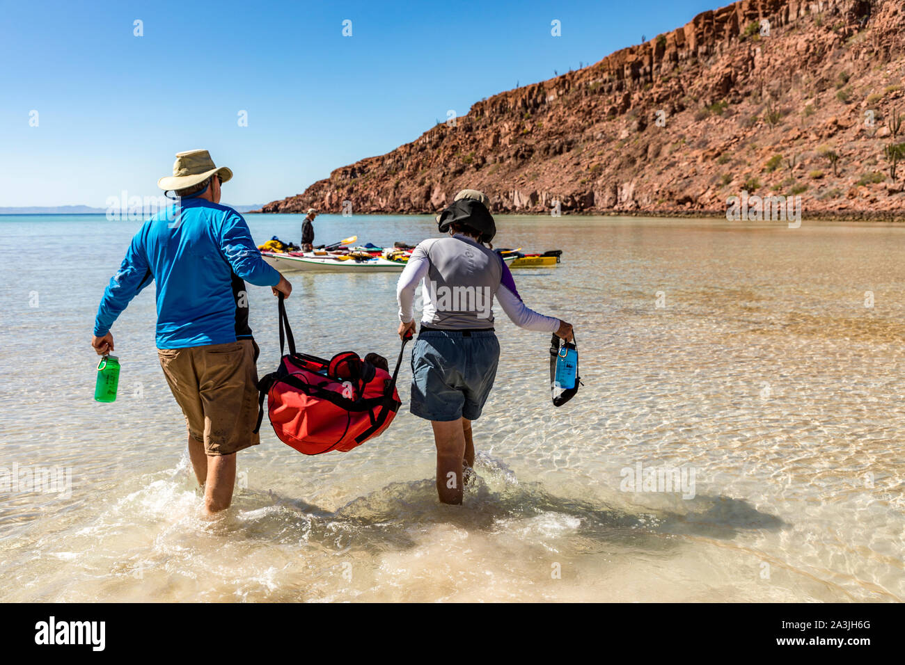 Tourists load sea kayaks in a bay off Isla Espíritu Santo in the Gulf ...