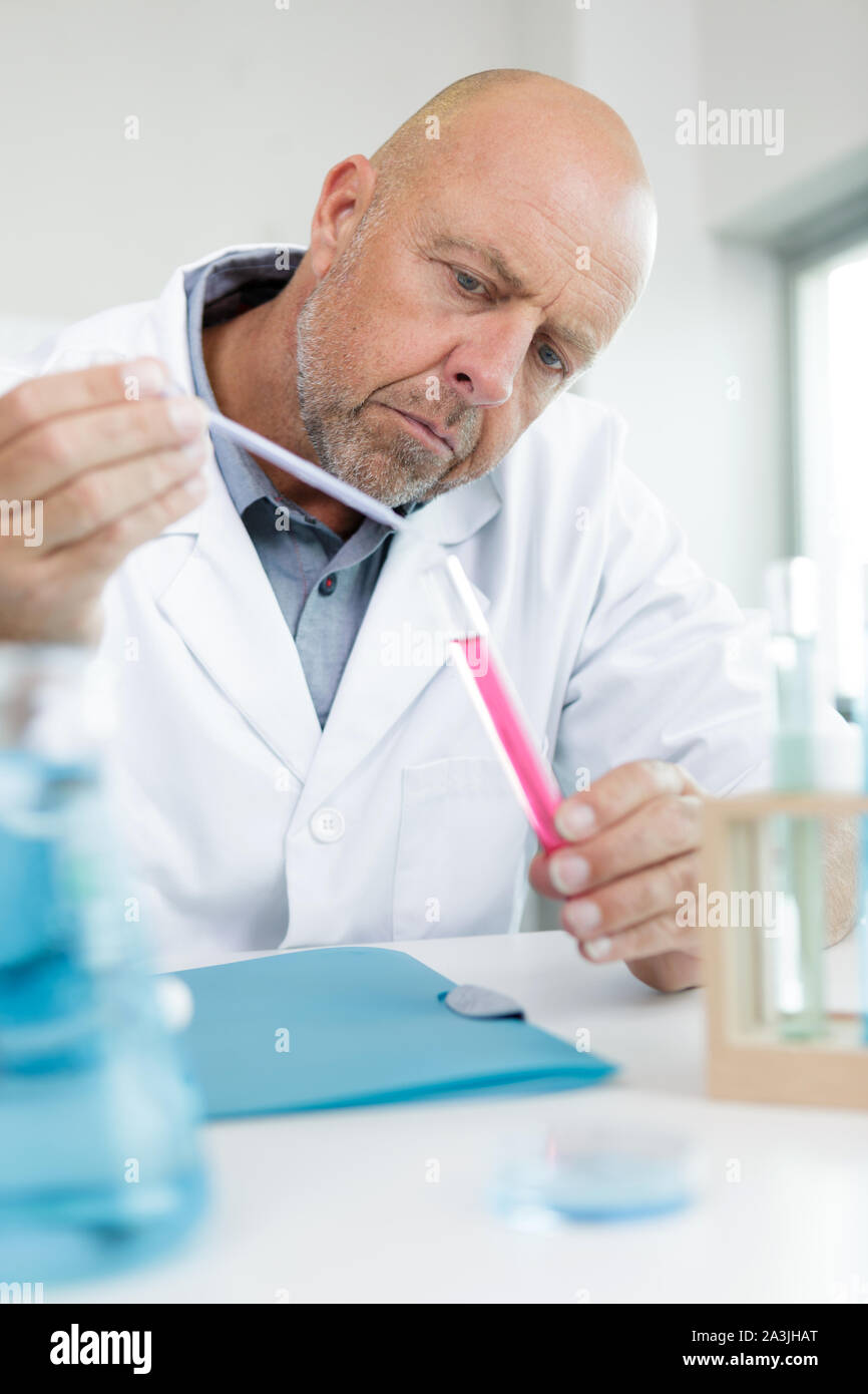 lab worker in uniform testing new substance Stock Photo - Alamy