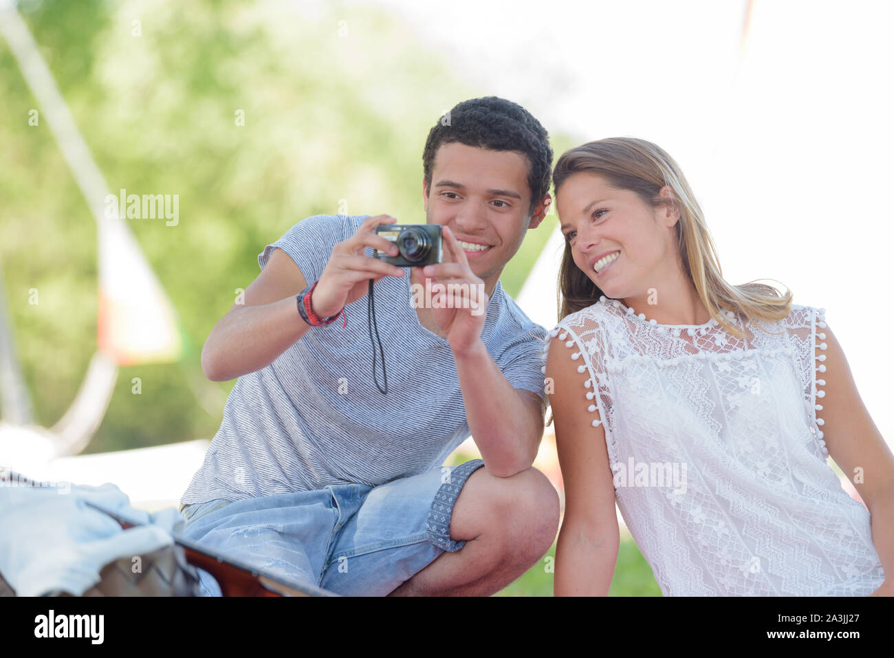 photographer showing a picture to her friend Stock Photo - Alamy