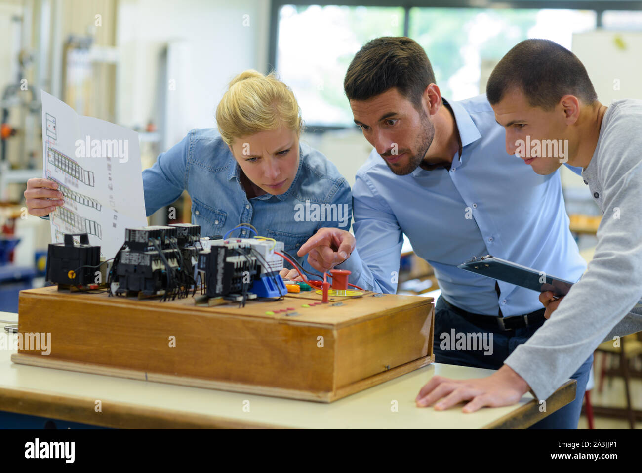 students and teacher looking at electronic circuit board Stock Photo ...