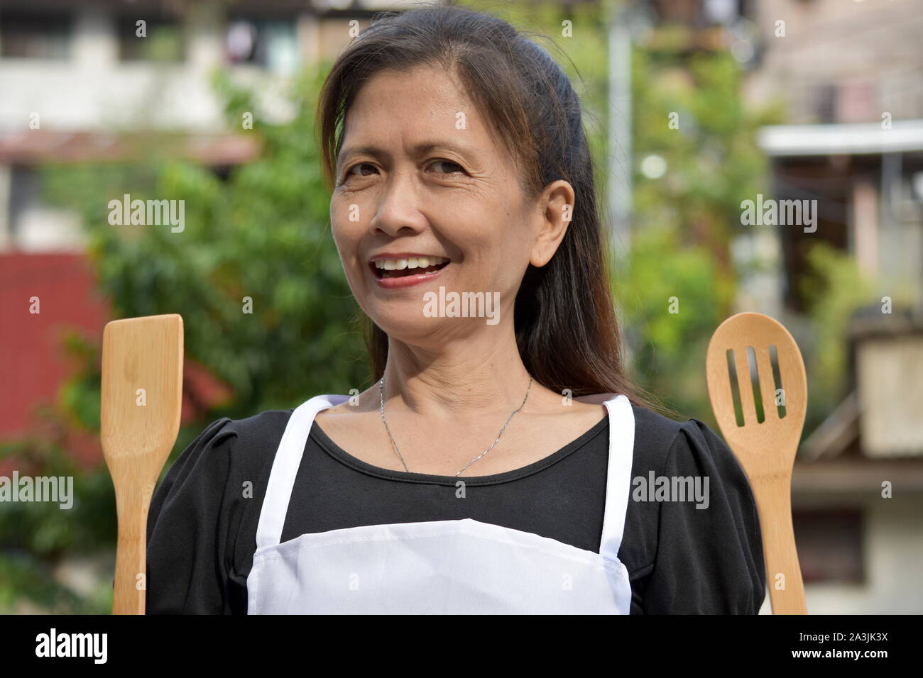 Happy Female Cook Chef With Kitchen Utensils Stock Photo - Alamy