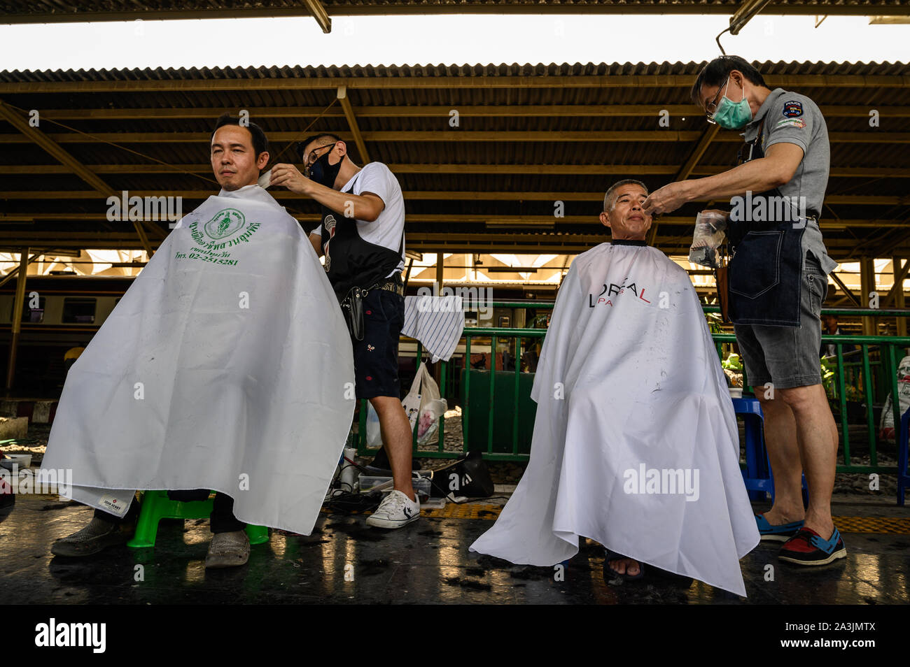 Men getting haircuts at Hua Lamphong Station, Bangkok, Thailand Stock ...
