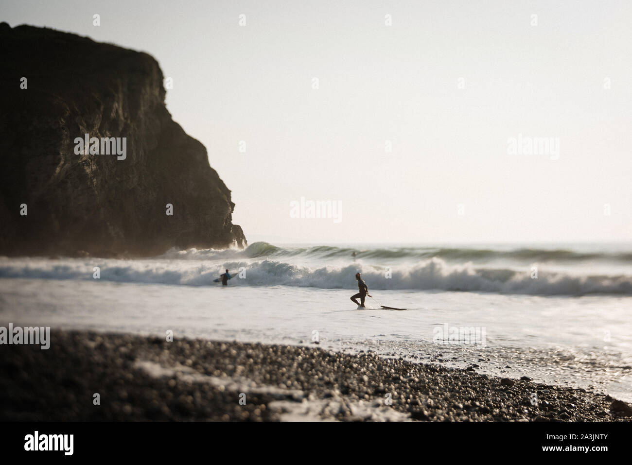 Surfers in the Water on Cornish Beach Stock Photo - Alamy