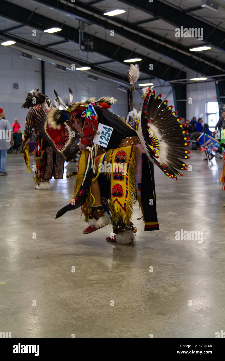 Native American dancer dressed in full regalia at a Pow Wow where ...