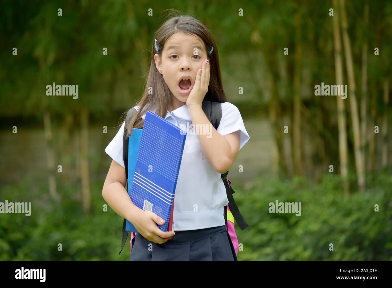 A Shocked Filipina Person With Notebooks Stock Photo - Alamy