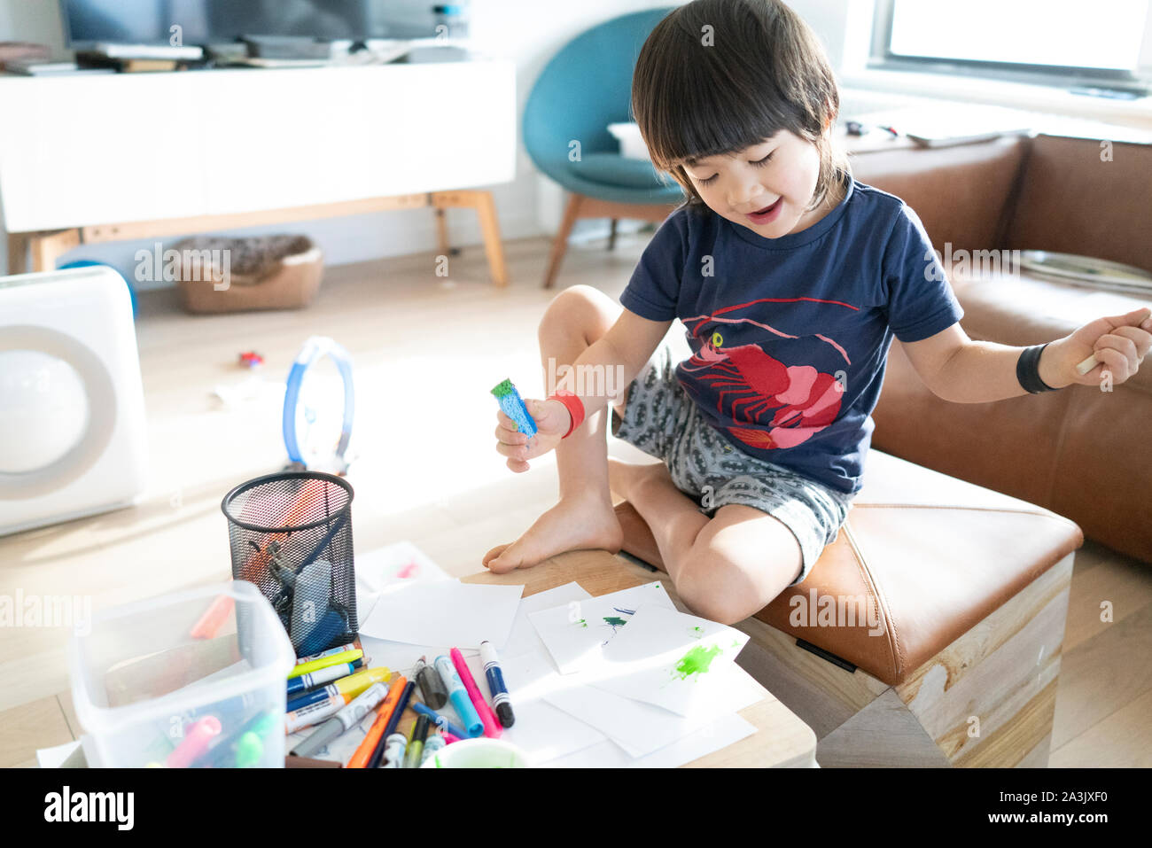 boy making art with dinosaur Stock Photo - Alamy