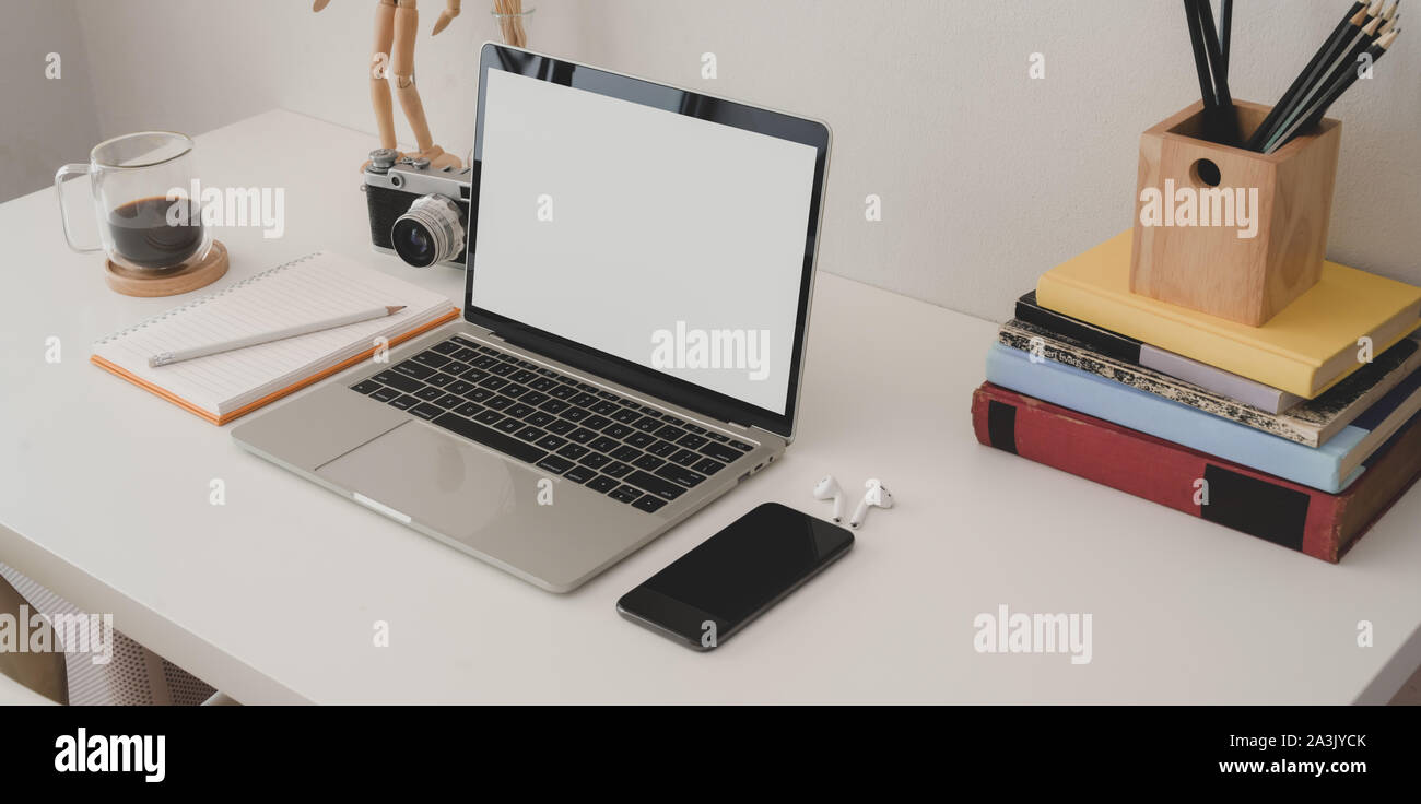 Close-up view of modern office room with open blank screen laptop ...
