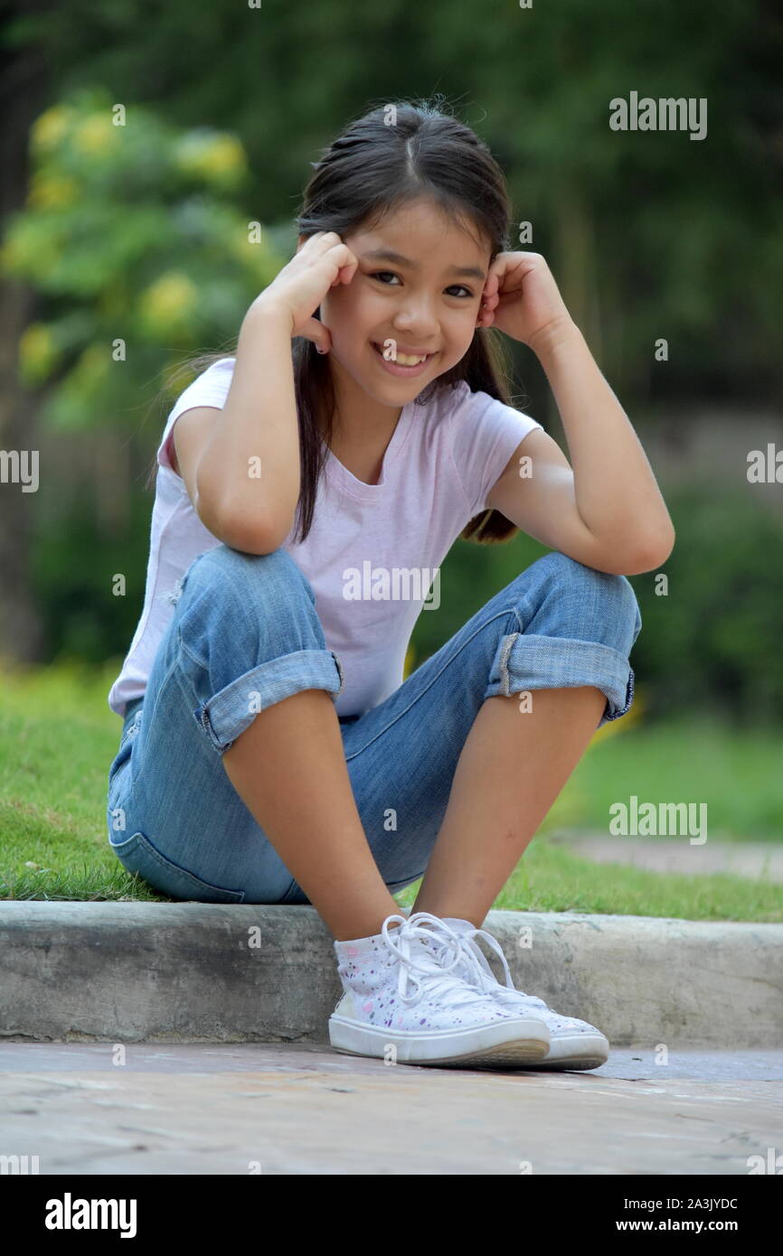 A Happy Girl Child Sitting Stock Photo - Alamy