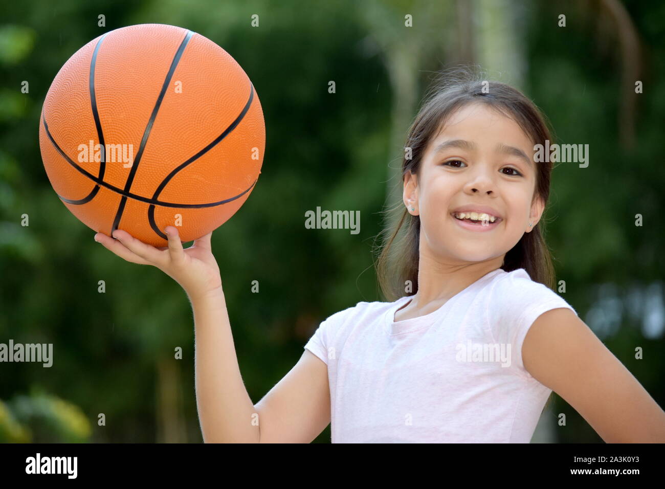 Happy Female Athlete Child Basketball Player With Basketball Stock ...