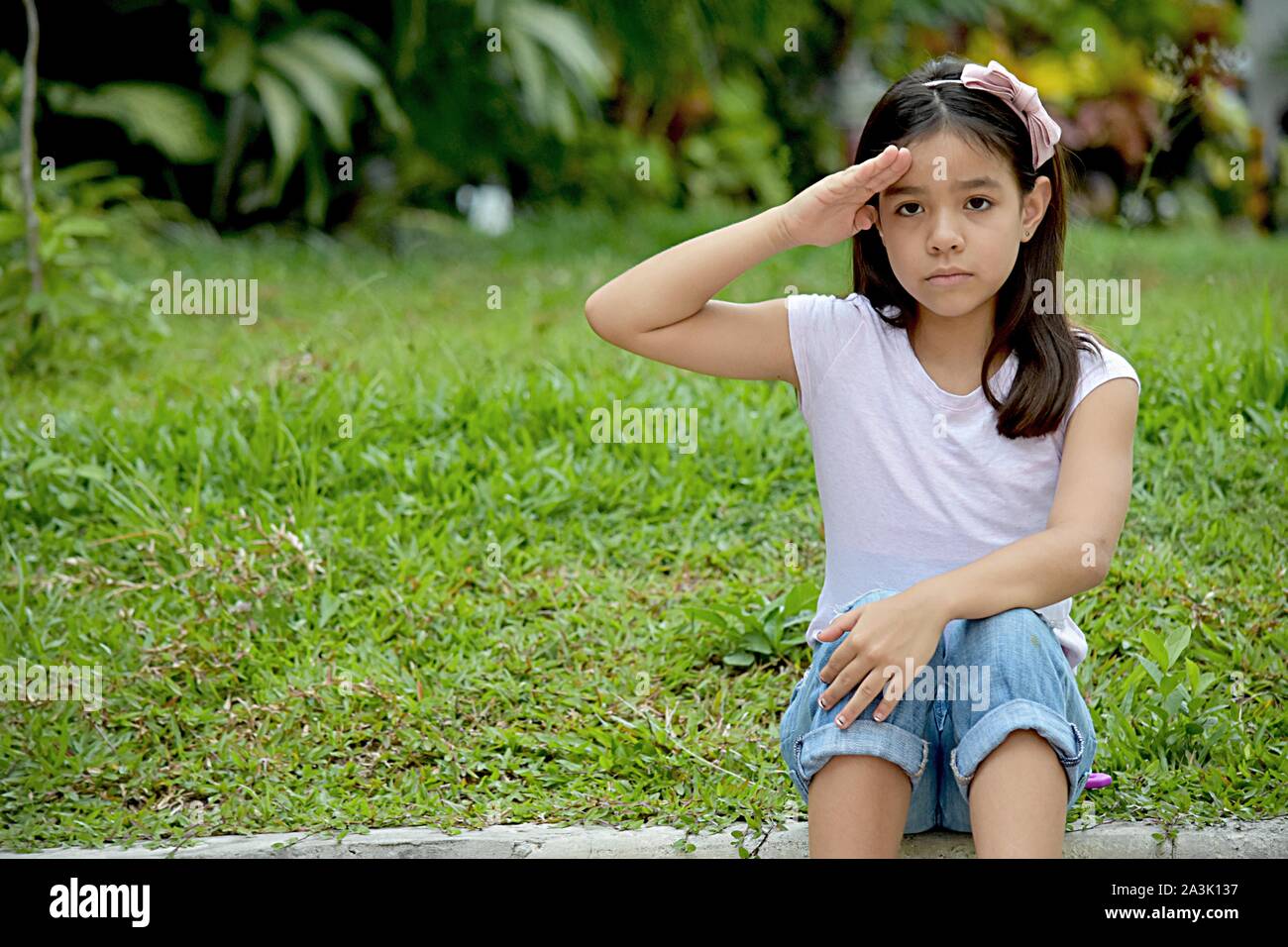A Young Diverse Girl Saluting Stock Photo - Alamy