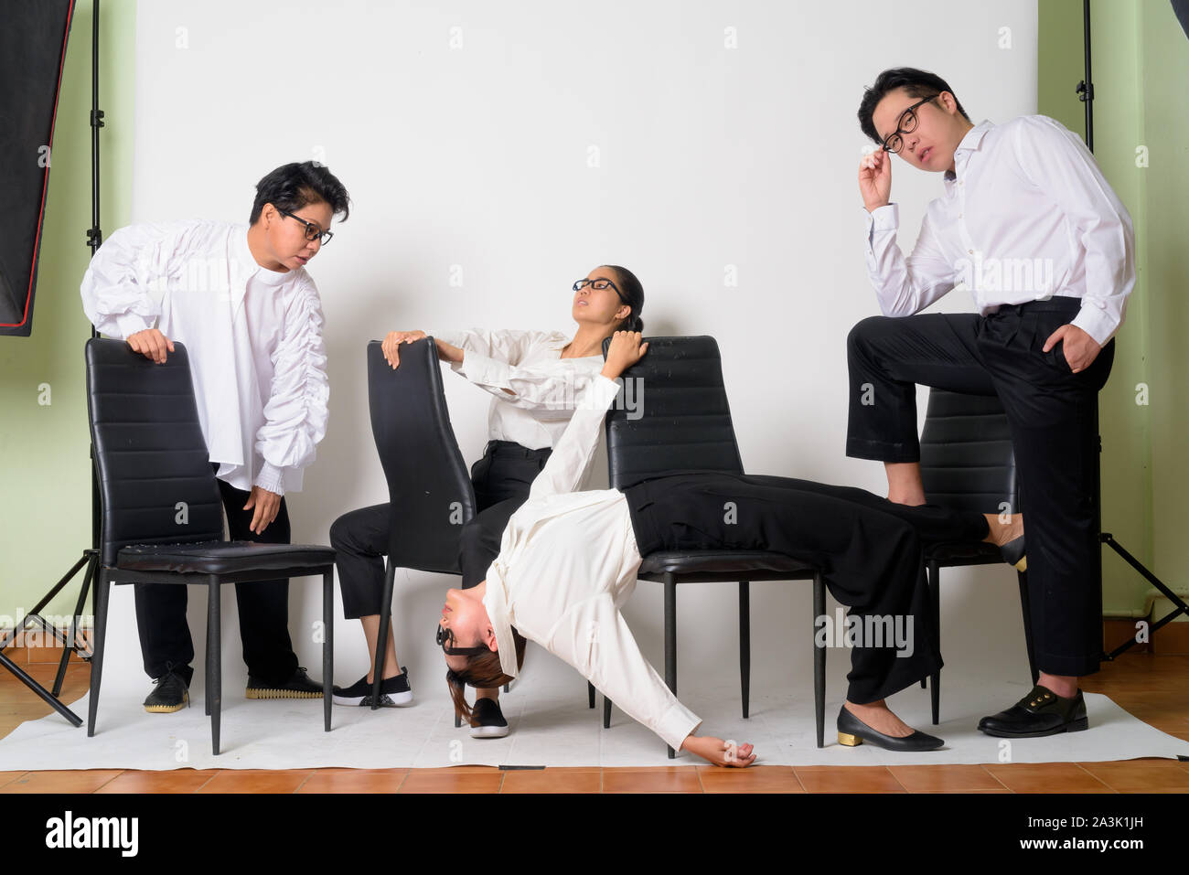 Group shot of stressed Asian business people looking tired and ...