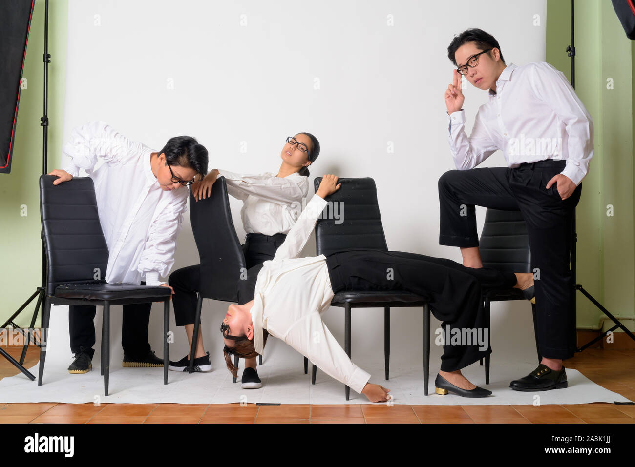 Group shot of stressed Asian business people looking tired and ...