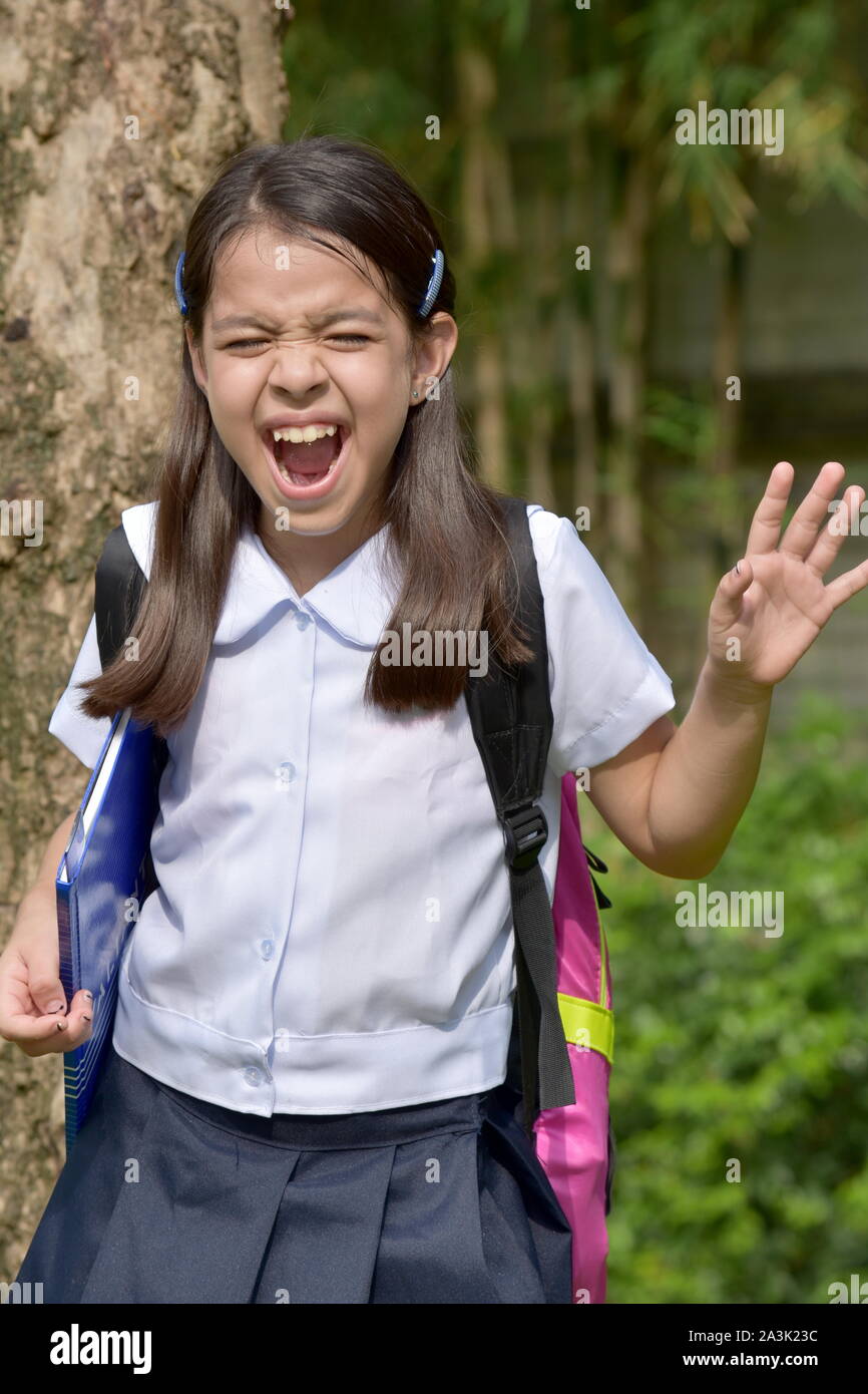 Angry Filipina Student Child With Notebooks Stock Photo - Alamy