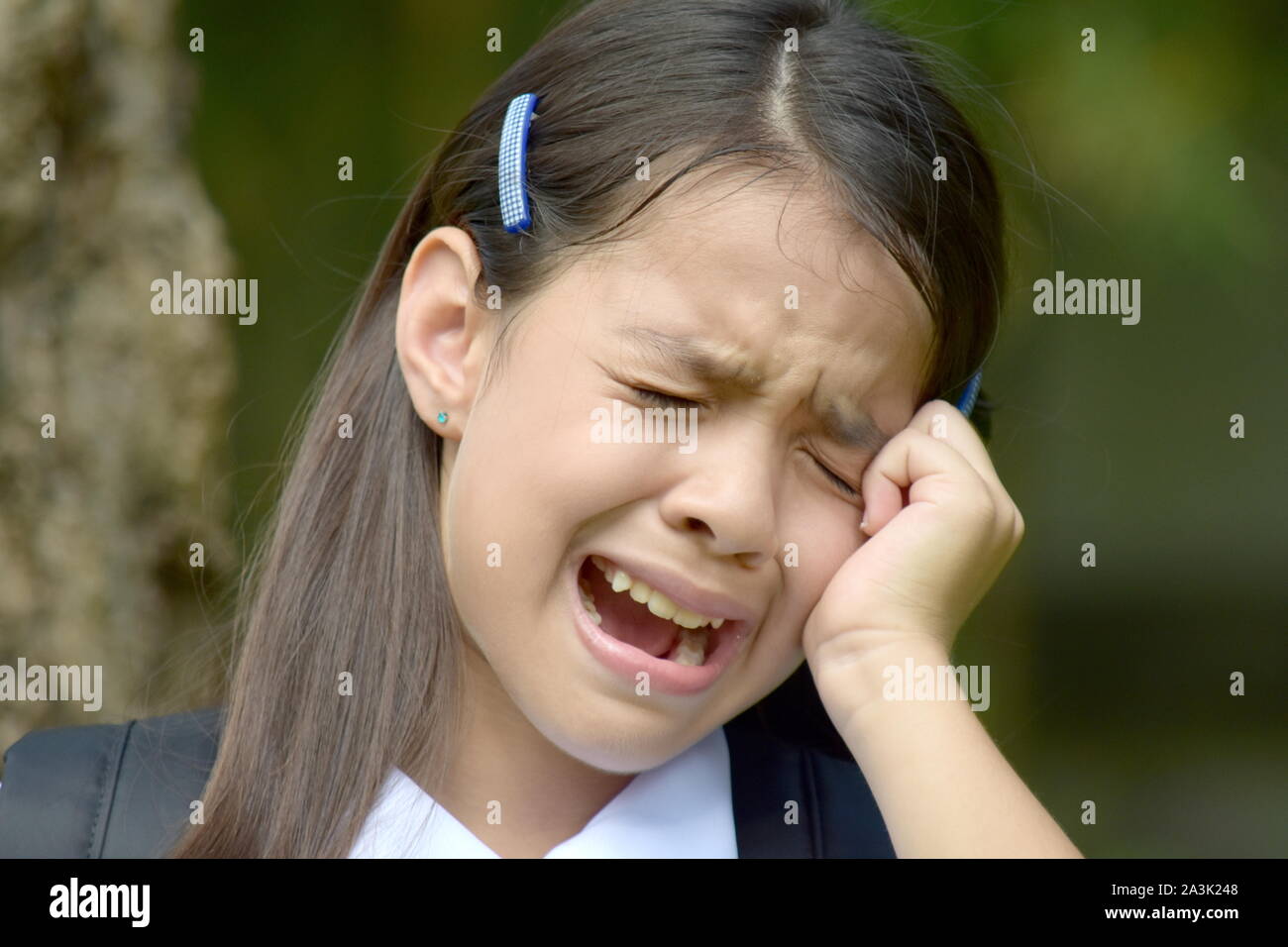 Crying Cute Minority School Girl Wearing School Uniform Stock Photo - Alamy