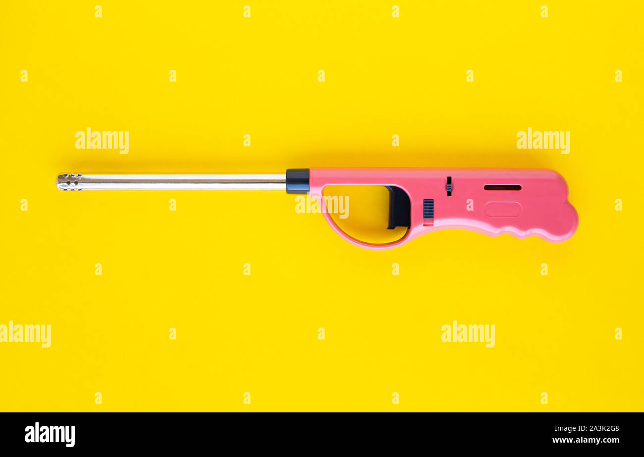 Gas lighter gun for gas-stove on a yellow background Stock Photo - Alamy
