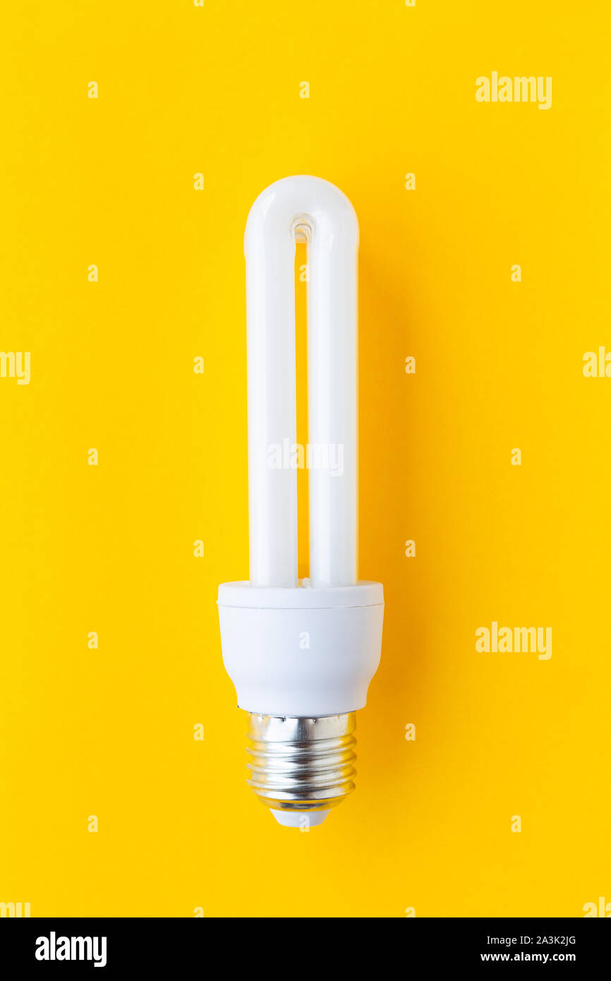 Energy saving lights on a yellow background Stock Photo - Alamy