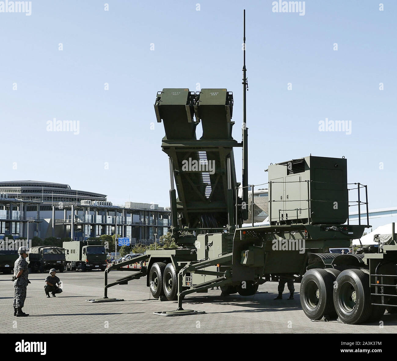 Japanese Air Self-Defense Force personnel install a missile interceptor ...