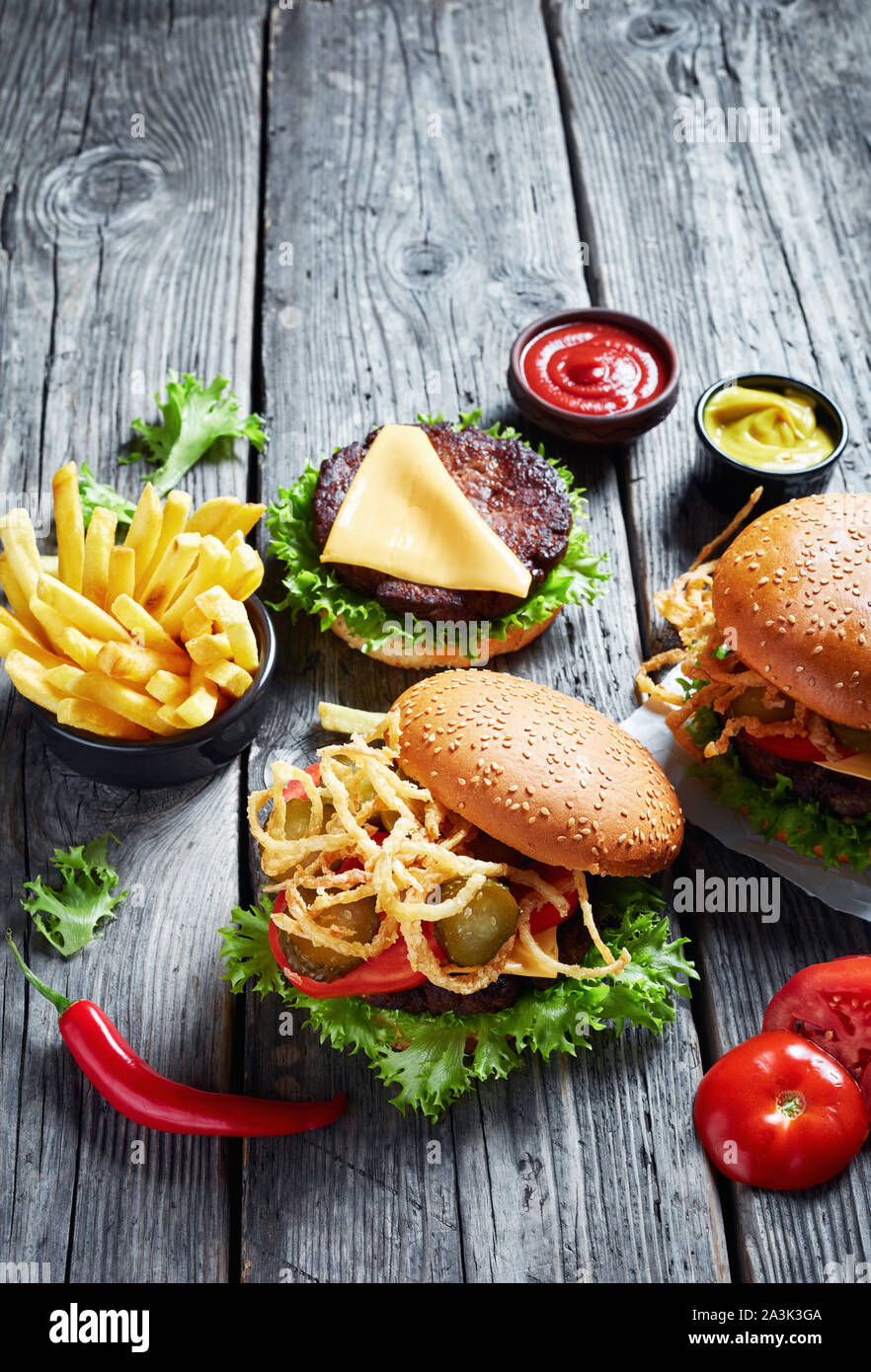three Cheeseburgers with beef patties, cheddar cheese, crispy fried ...
