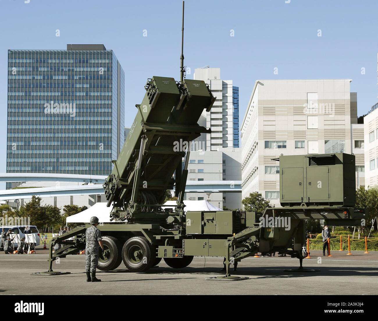 Japanese Air Self-Defense Force personnel install a missile interceptor ...