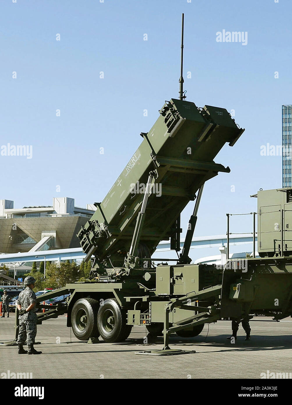Japanese Air Self-Defense Force personnel install a missile interceptor ...