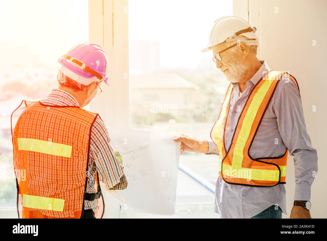 two builder engineer working together consulting about building floor ...