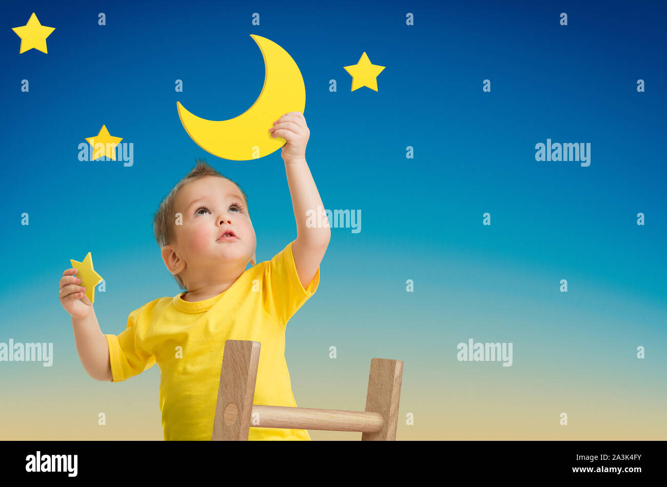 Kid attaching stars to night sky using ladder Stock Photo - Alamy