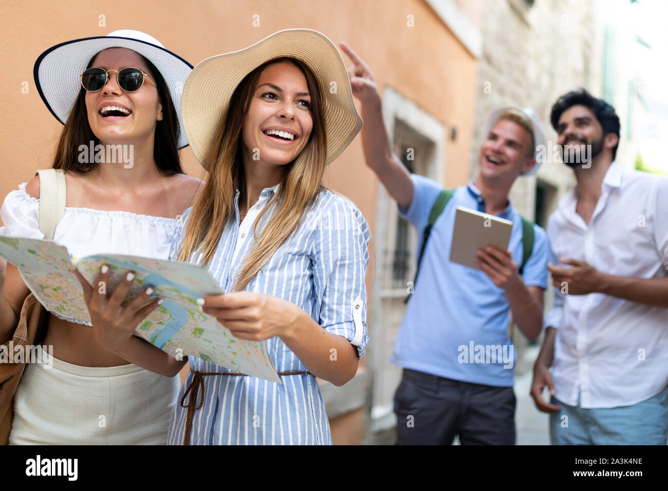 Happy group of friends tourists sightseeing in city on vacation Stock ...