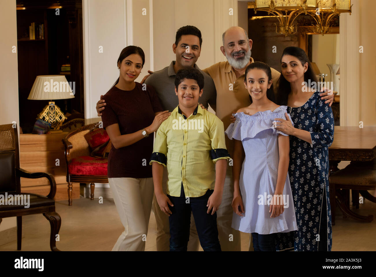 A family stands close together and smiles Stock Photo - Alamy