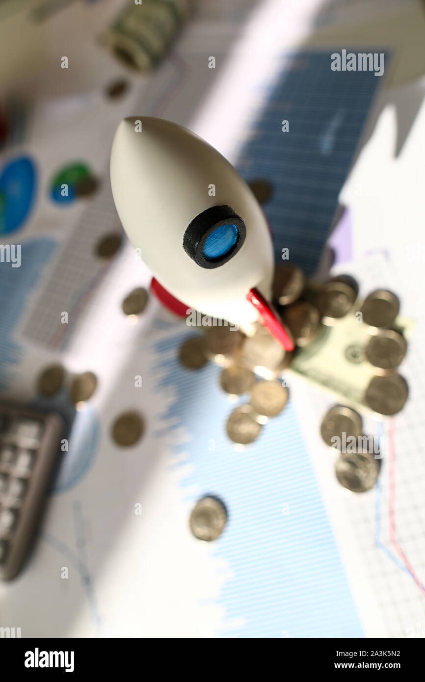 Metallic currency with rocket Stock Photo - Alamy