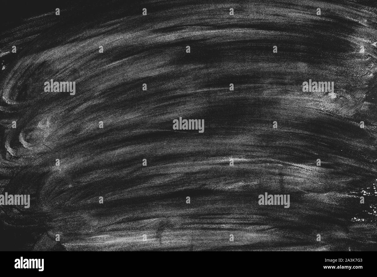 Empty chalk board background with stains. White chaotic chalk stains on ...