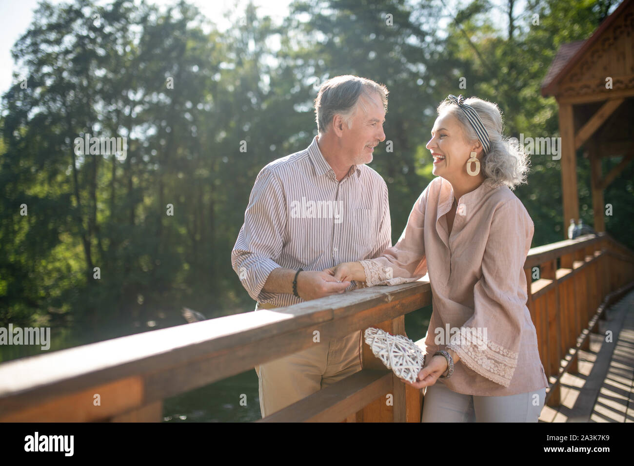 Wife hanging little heart on the bridge with husband Stock Photo - Alamy