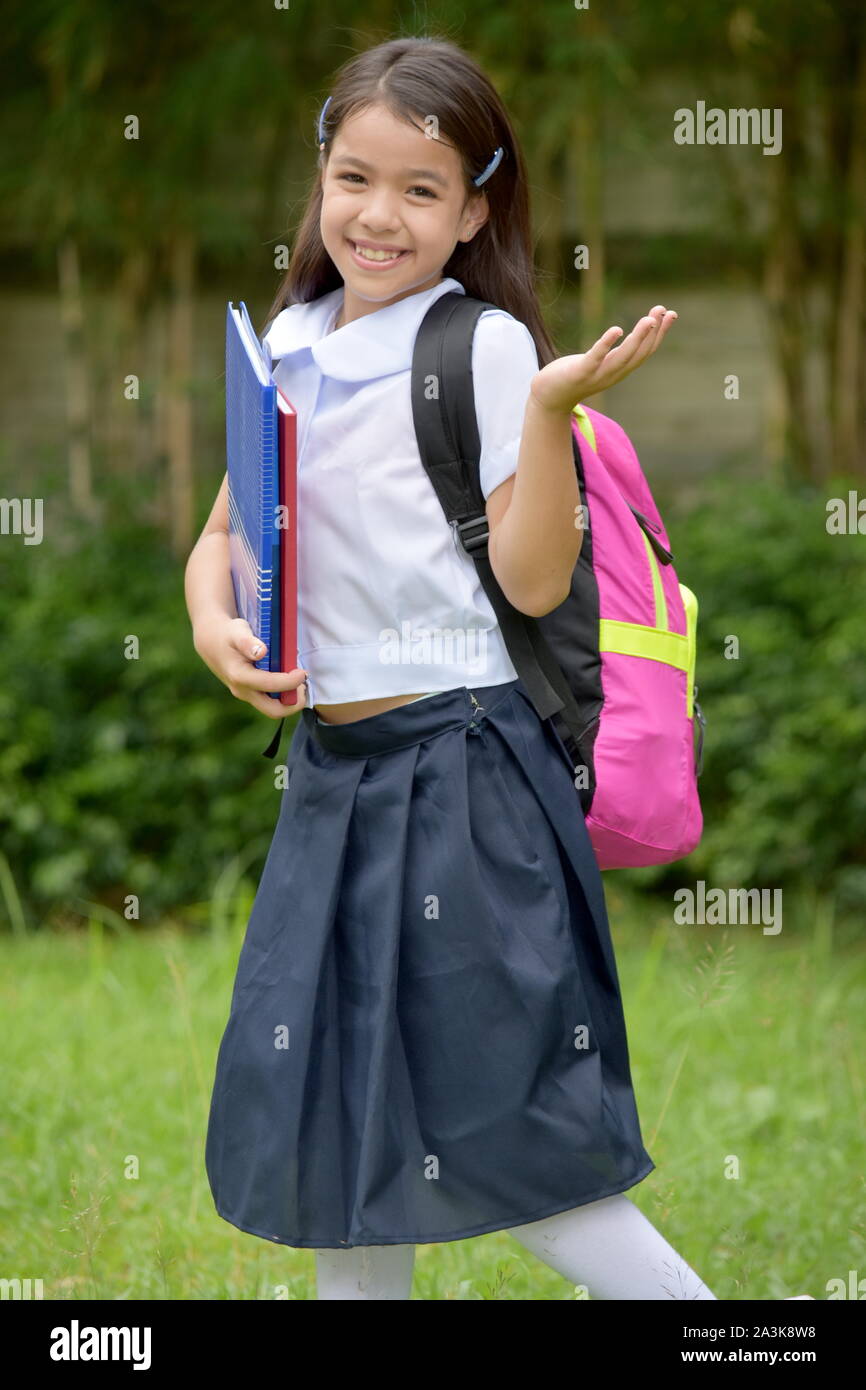 An Undecided Student Child With Books Stock Photo - Alamy