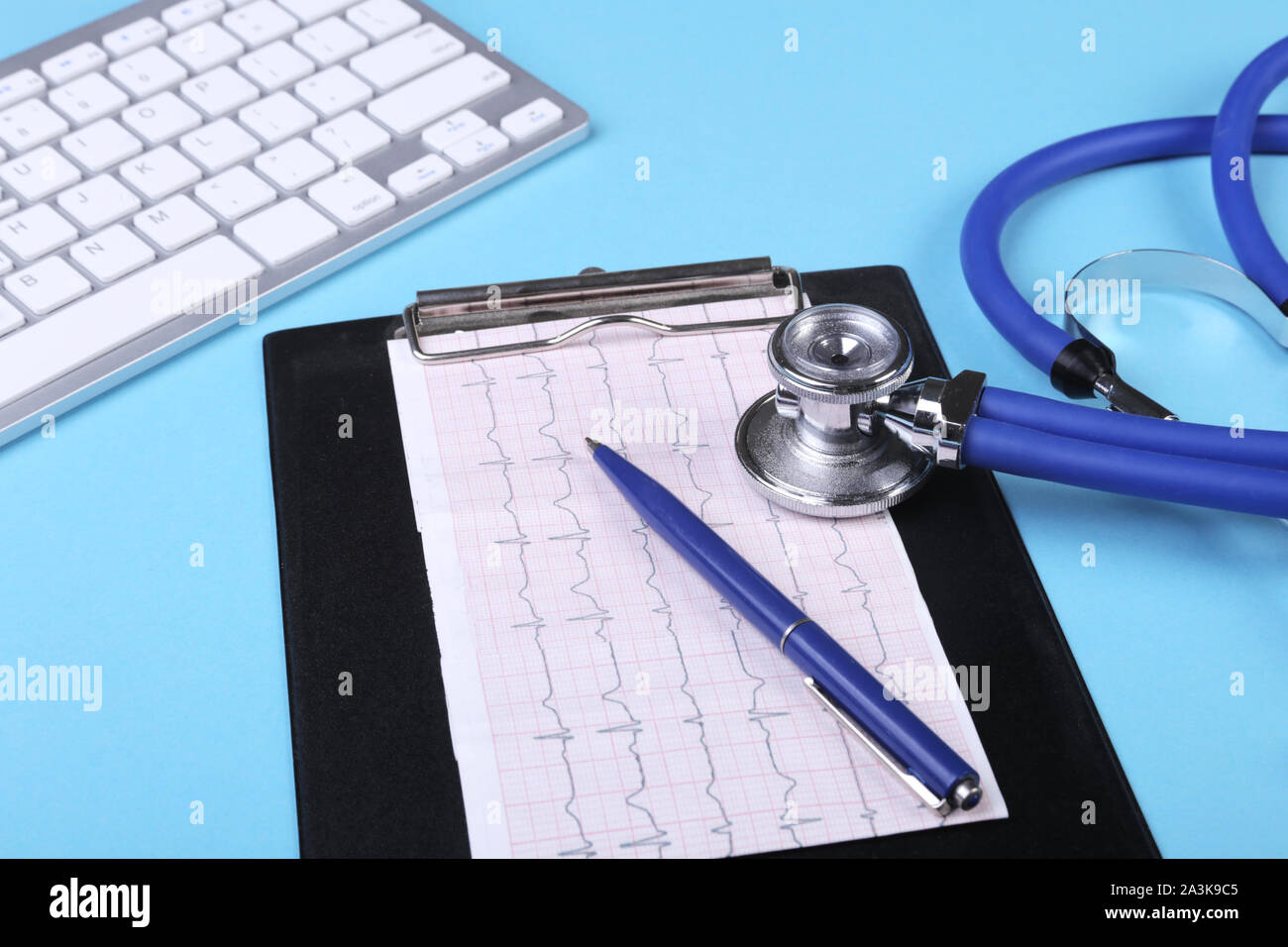 keyboard and Medical stethoscope lying on cardiogram chart closeup ...